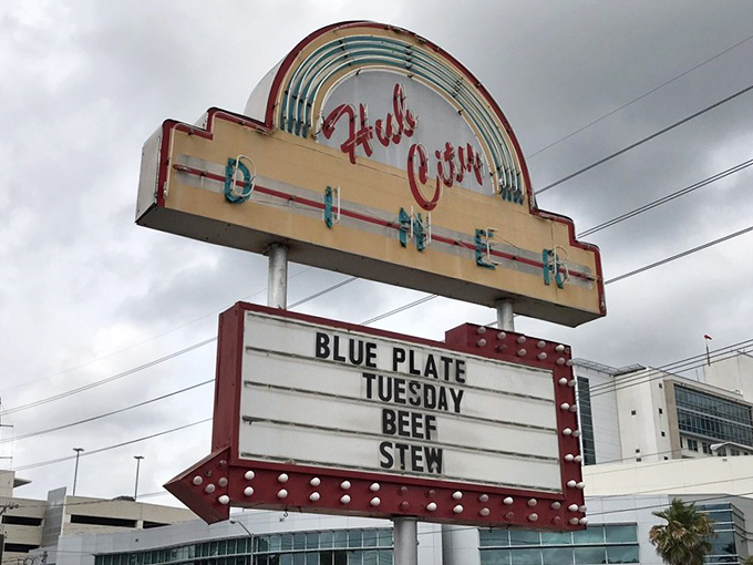 The roadside marquee announces daily specials like a town crier, drawing hungry travelers with promises of Blue Plate Tuesday beef stew.