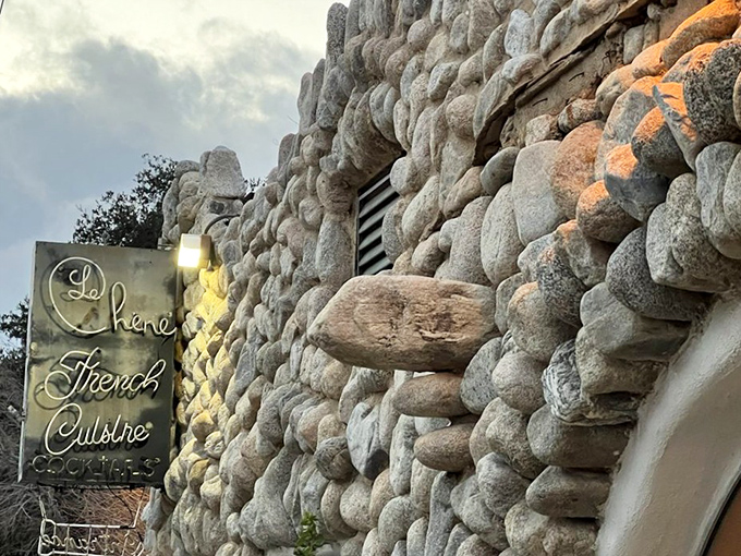 The sign glows like a beacon for hungry travelers. Follow it like sailors to a lighthouse, but with better food waiting.