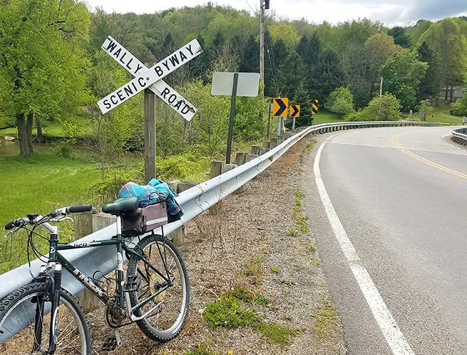 The intersection where roads become journeys. That leaning bicycle suggests someone found something worth stopping for&mdash;perhaps you should too.