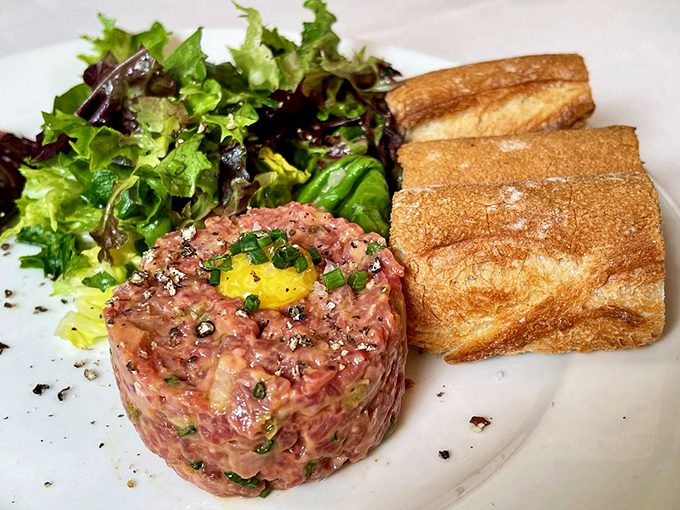 Steak tartare with a golden egg yolk crown&mdash;raw perfection for the culinary brave. Trust me, this is worth the leap of faith.