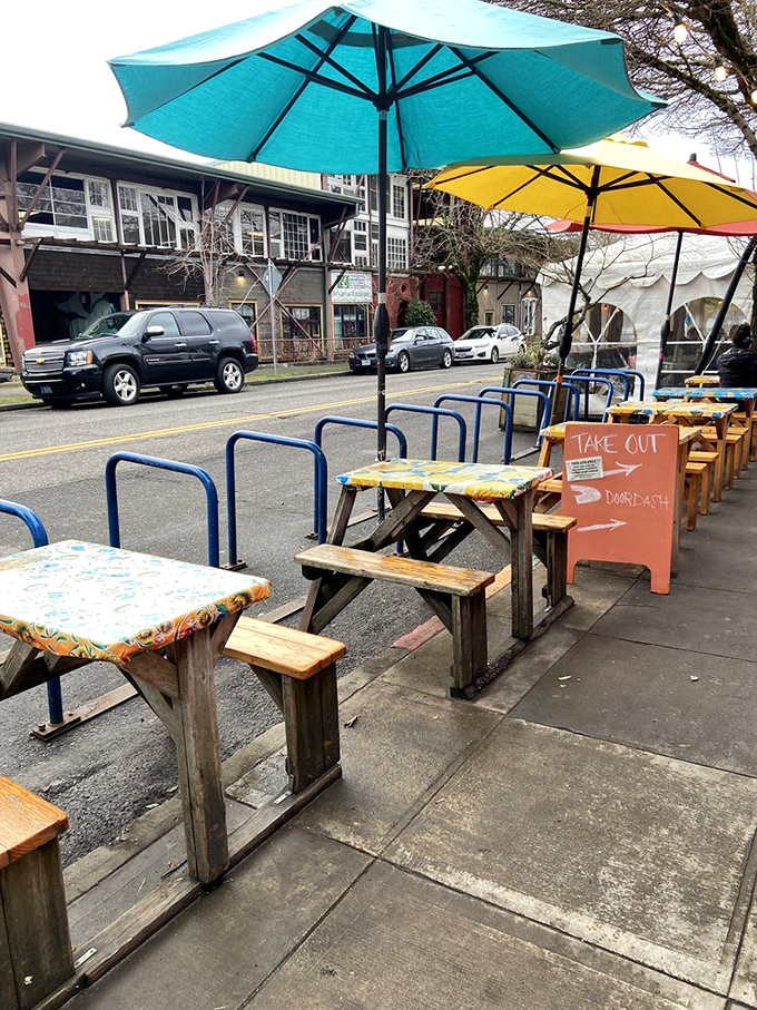 Sidewalk seating that says, "Life's too short for boring lunches," with umbrellas adding that perfect touch of vacation vibes.