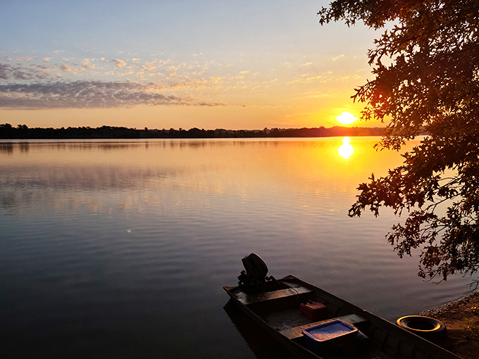 Nature's light show reflects perfectly on still waters as day bids farewell. The kind of sunset that makes you forget to check your phone.