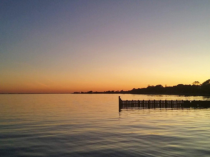 A Great South Bay sunset paints the sky in impossible colors, turning even the most casual evening into something that feels remarkably like perfection.