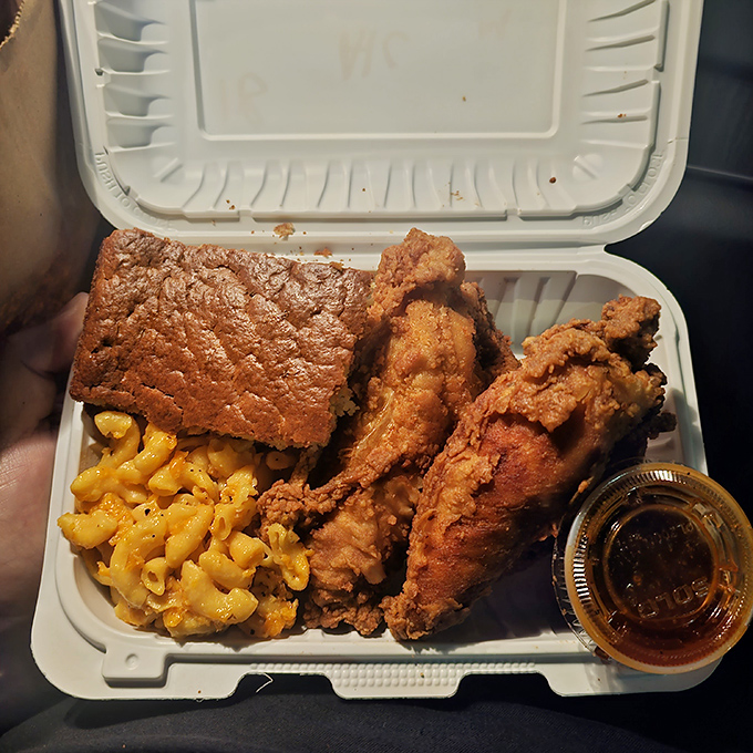 The ultimate to-go package: crispy chicken, mac & cheese, and cornbread&mdash;proof that true happiness can indeed fit in a styrofoam container.