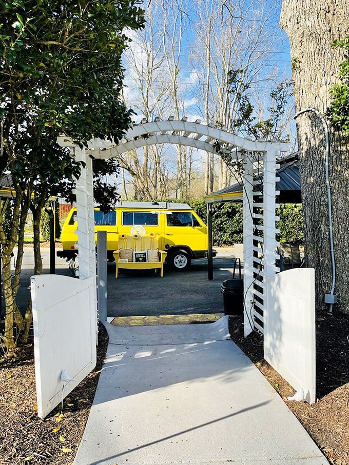 A cheerful yellow van framed by a white garden arch&mdash;like the gateway to a Wes Anderson film where everyone eats really, really well.