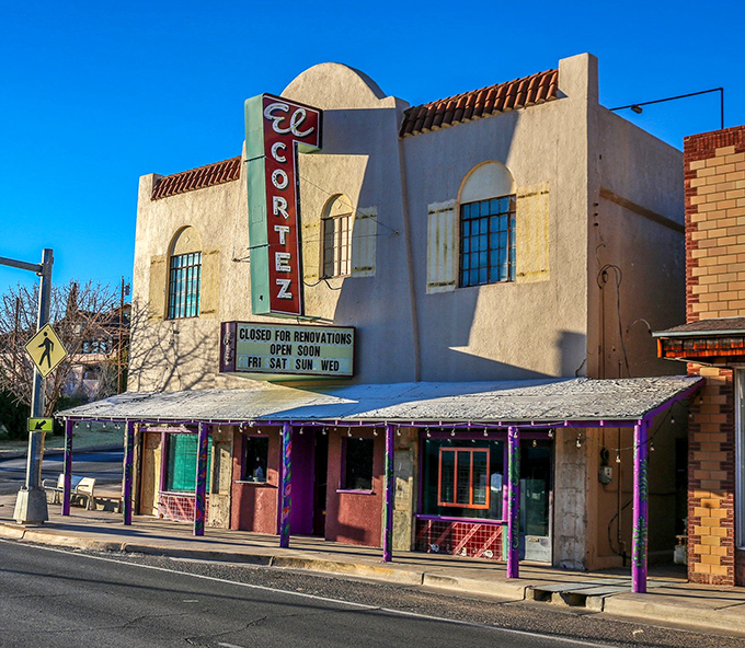The historic El Cortez Theatre stands as a pastel-hued time capsule, its vintage marquee promising entertainment in a building that's a show itself.