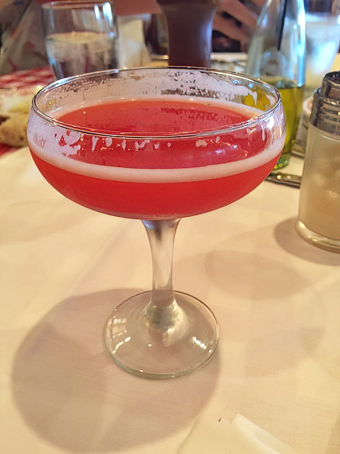 A crimson cocktail that doesn't just complement your meal—it announces itself like a well-dressed guest who knows they belong at the best table.