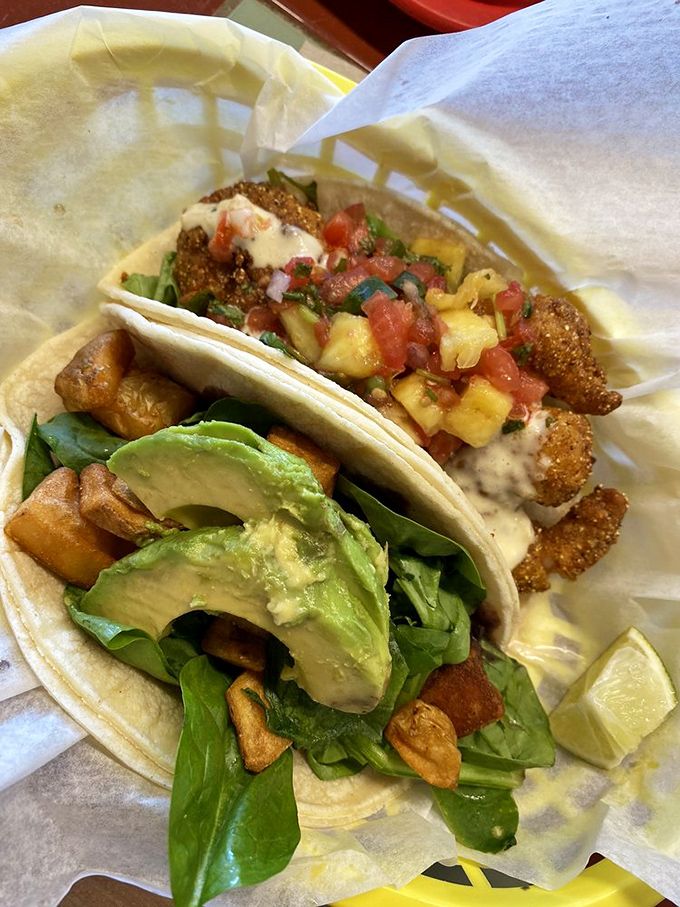 Two tacos that tell different stories: one of crispy avocado dreams, the other of seafood adventures, both ending in delicious satisfaction.