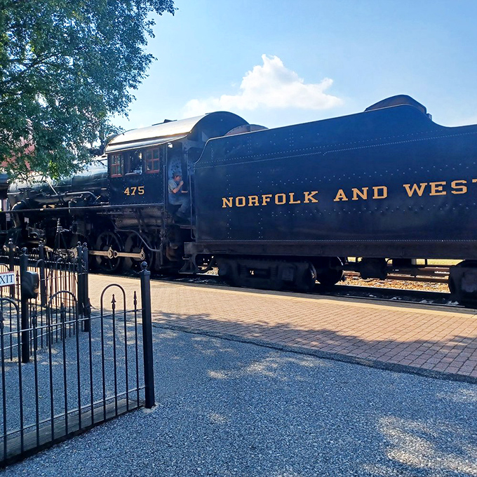 Norfolk & Western's mighty 475 gleams in the sunshine, its gold lettering promising journeys to places that exist both on maps and in memories.
