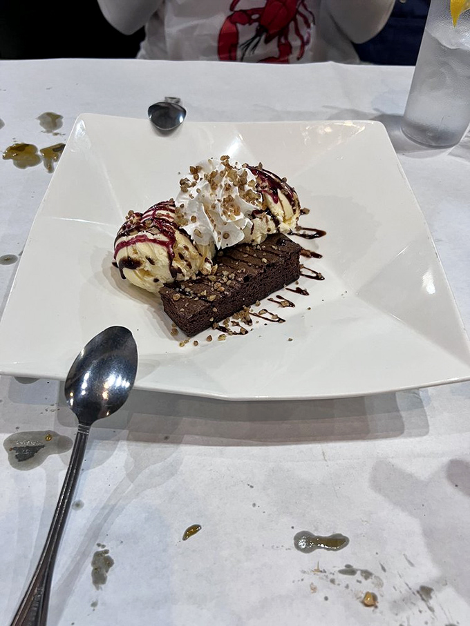 A brownie topped with ice cream&mdash;because after conquering mountains of seafood, you deserve a sweet victory lap.