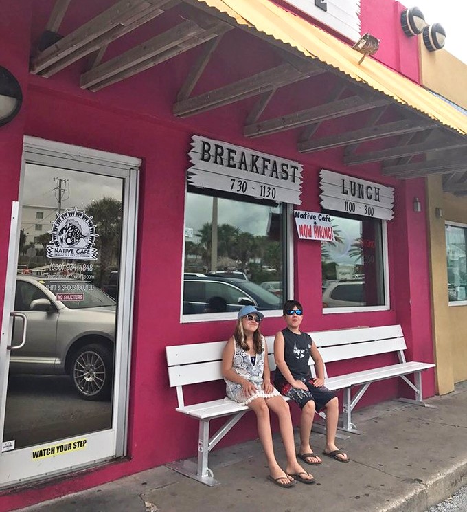 The waiting bench outside says everything about this place: bright, welcoming, and worth sitting for however long it takes.