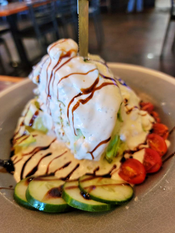 A wedge salad that's dressed to impress. With drizzles of balsamic reduction and a mountain of toppings, it's what other salads aspire to be.