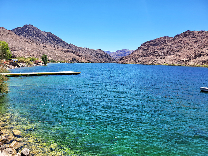 The water so impossibly blue against the rusty mountains, it looks like nature's version of a contrast filter gone wonderfully wild.