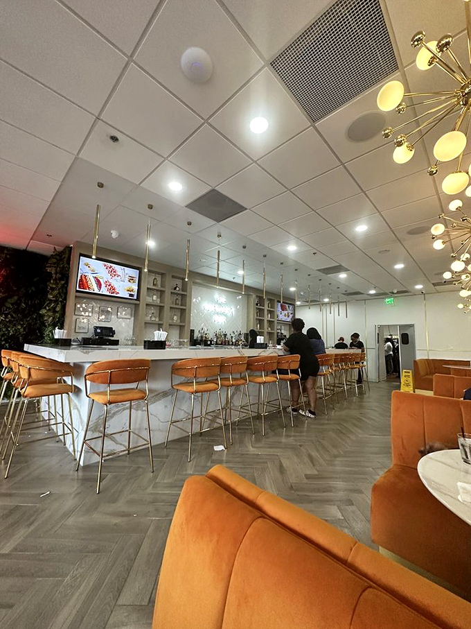 The sleek bar area beckons with promises of perfectly crafted morning cocktails and premium spirits for elevated breakfast experiences.