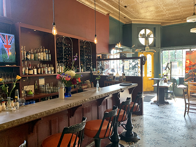 The bar area combines vintage charm with modern sensibilities, offering a perfect perch to sip local brews while waiting for your table.