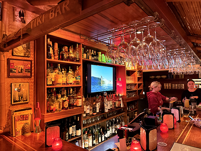 The tiki bar isn't just serving drinks—it's dispensing liquid vacations, complete with surfing videos to remind you you're just steps from the Pacific.
