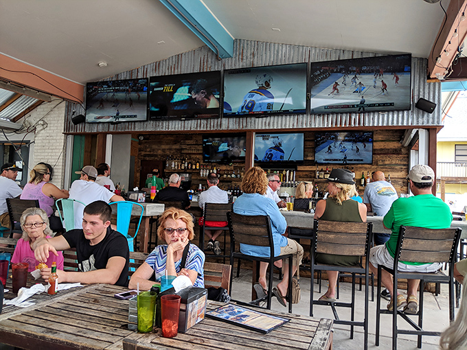 The bar scene where locals and tourists blend seamlessly, united by sports on TV and the universal language of good food and cold drinks.