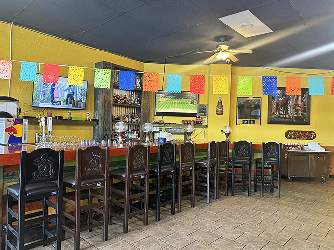 The bar area: where colorful papel picado banners meet cold beverages. A festive corner that promises good times and better stories.