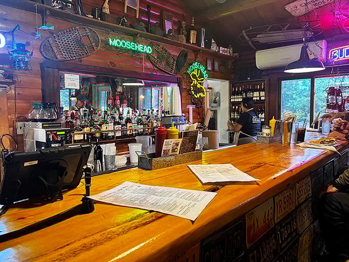 The bar where wilderness stories get better with each telling. That neon Moosehead sign has witnessed tales that grow taller than the surrounding pines.