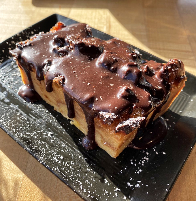 Bread pudding draped in chocolate that makes dessert non-negotiable. Because after all that seafood, your sweet tooth deserves equal attention.