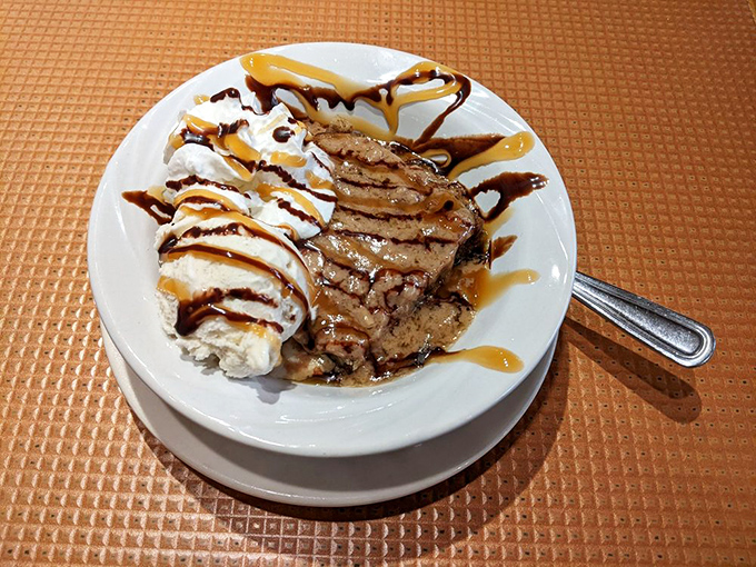 This isn't dessert; it's therapy on a plate. Warm bread pudding with ice cream melting into rivers of caramel and chocolate bliss.