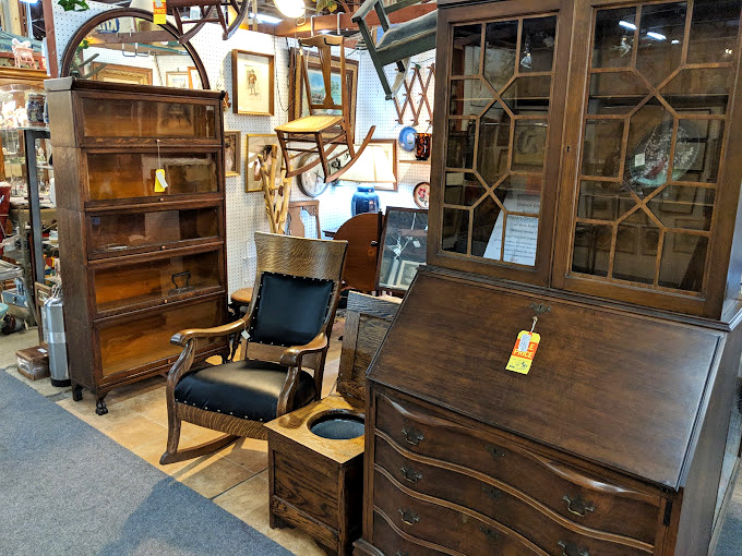 That secretary desk has probably held more secrets than a therapist, and now it's ready to organize your modern life with vintage flair.