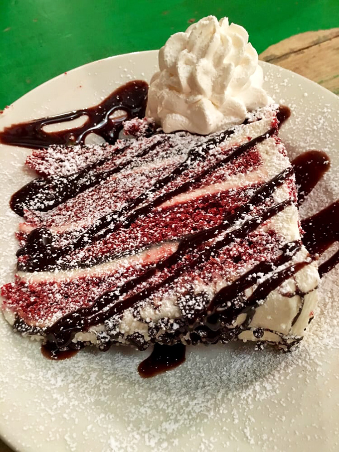 This dessert doesn't whisper sweet nothings&mdash;it shouts them, with layers of what appears to be cheesecake drizzled with chocolate and topped with whipped cream.