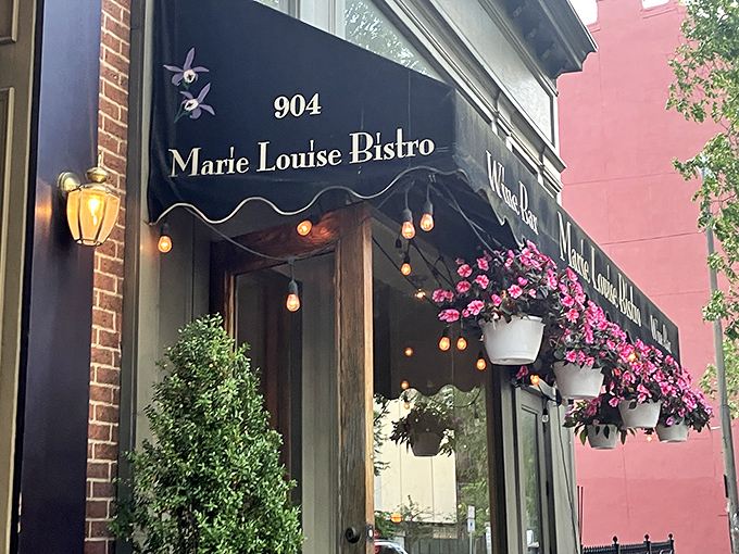 The bistro's elegant facade whispers rather than shouts, adorned with flowers that seem to say, "Yes, something wonderful is happening inside."
