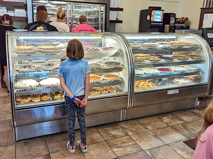 The pie case of childhood dreams. That little one's posture says everything about the anticipation of choosing your slice of heaven.