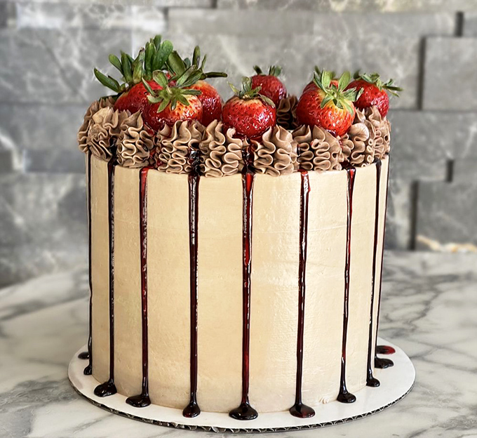 This isn't just cake&mdash;it's a vertical celebration with chocolate drips that seem to defy gravity and strawberries standing guard at the summit.