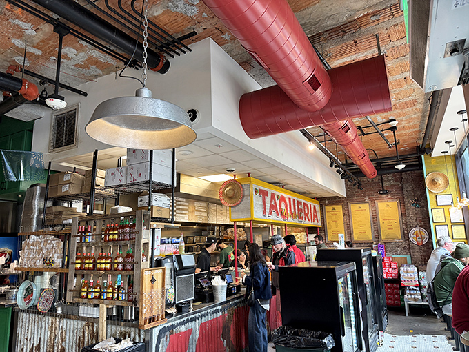 The command center where burrito dreams become reality. Those red pipes overhead? They're pumping pure flavor throughout the establishment.