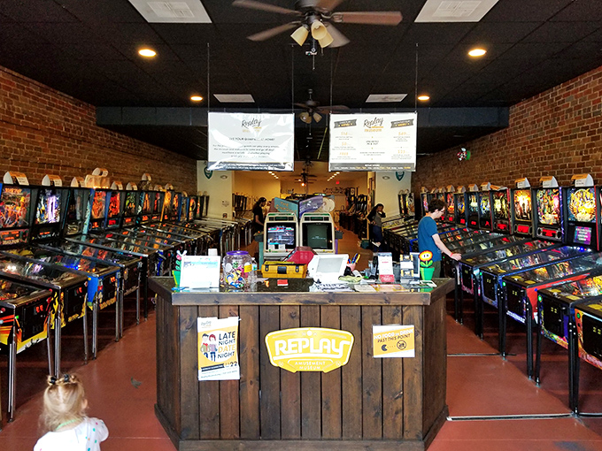 Command central! The rustic wooden counter serves as mission control for this spaceship of nostalgia, where staff stand ready to help when your favorite game acts temperamental.