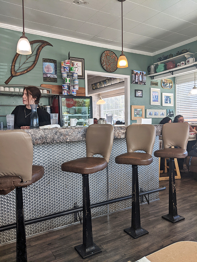 The counter—where solo diners become temporary family, watching the short-order ballet while coffee refills appear like magic from attentive servers.