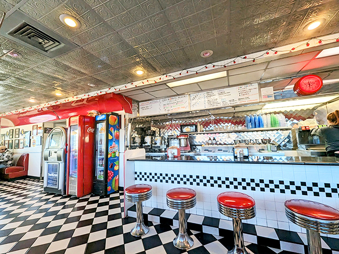 The counter where magic happens&mdash;chrome stools, checkered floors, and the promise of comfort food that makes you wonder why you'd ever eat anywhere else.