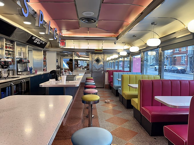 Classic diner counter seating meets candy-colored booths. It's where solo diners become regulars and strangers become friends over coffee refills.
