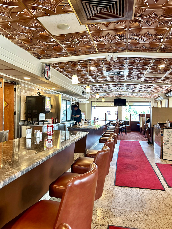 Where the magic happens &ndash; copper-tiled ceiling, red carpet runway, and those swiveling counter seats where regulars hold court and servers know your order before you sit down.