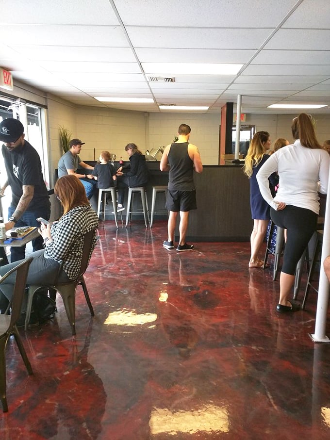 The red-tinted concrete floor has witnessed countless "first bite" faces. Where Orlando locals gather to worship at the altar of exceptional sandwiches.