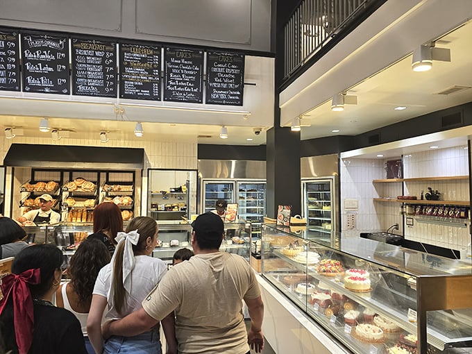 The display case pilgrimage&mdash;where customers line up for their turn at the glass altar of pastry perfection, eyes wide with sweet anticipation.