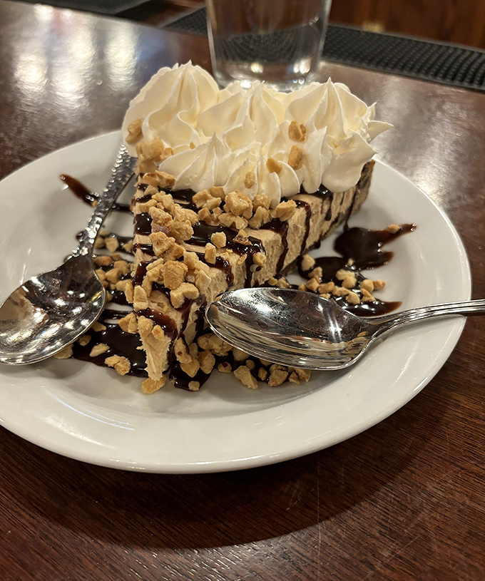 Dessert architecture that defies both gravity and willpower. This towering sweet finale makes "I'll just have a bite" the biggest lie you'll tell today.