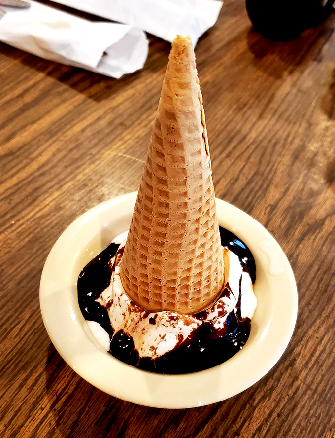 Ice cream in a waffle cone drizzled with chocolate sauce—proof that The Steak House knows how to start a meal and how to end one.