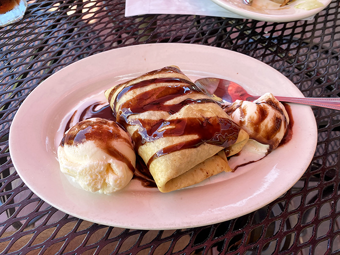 Dessert chimichangas drizzled with chocolate and served with ice cream—because ending a meal without something sweet is like a story without an ending.