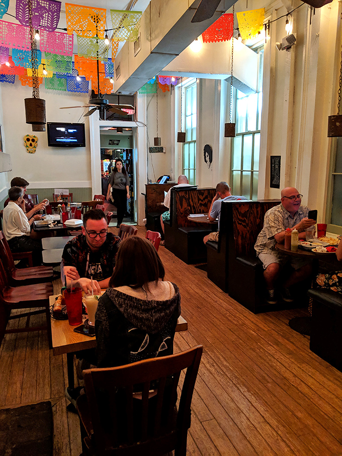 Colorful papel picado flags dance overhead as diners dive into conversation and cuisine &ndash; the true recipe for a perfect meal out.