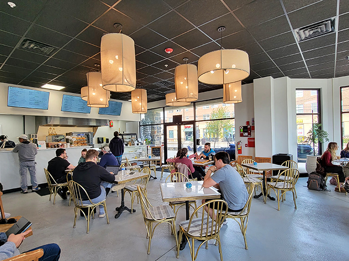 Where strangers become neighbors over coffee and cheesecake. The golden chairs aren't just seating&mdash;they're front-row tickets to Newark's daily symphony.