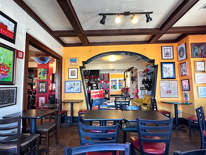 Art-filled walls and wooden beams create a space that feels both bohemian and welcoming. It's the living room you wish you had.
