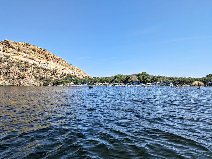 A patchwork of blue water, desert hills, and human joy seen from afar. Social distancing was never this beautiful or refreshing.
