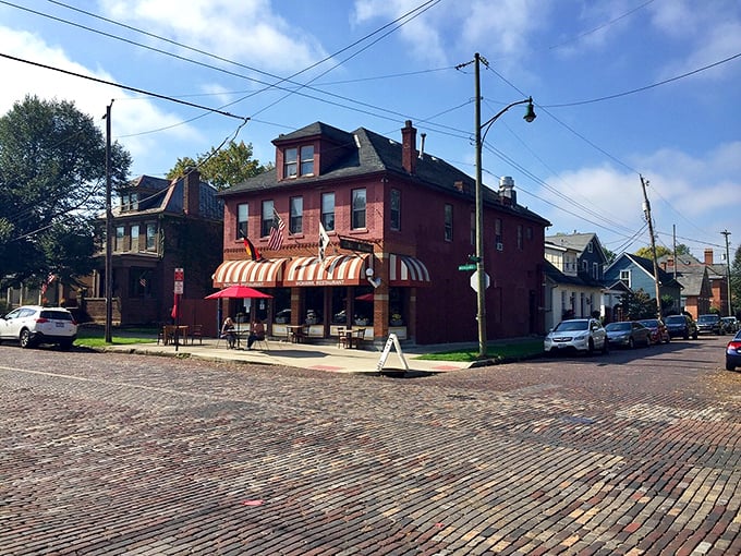 The Old Mohawk stands proudly on its corner, brick streets below and blue skies above, a cornerstone of German Village's timeless appeal.