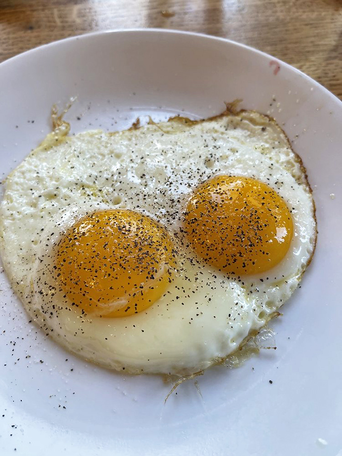 Two sunny-side up eggs staring back at you like breakfast's version of the Mona Lisa&mdash;simple perfection that needs no explanation.