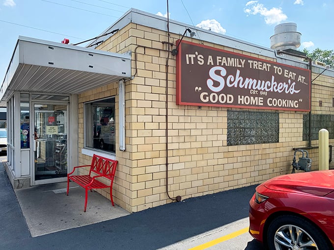 The welcoming entrance with its iconic sign and red bench &ndash; the gateway to comfort food paradise. Like stepping into your favorite relative's kitchen, if they happened to make world-class pie.