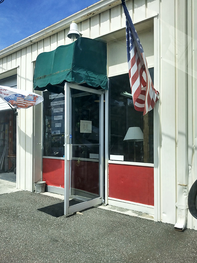 The entrance beckons with patriotic flair, promising treasures inside that HGTV designers would fight over in polite, hushed tones.