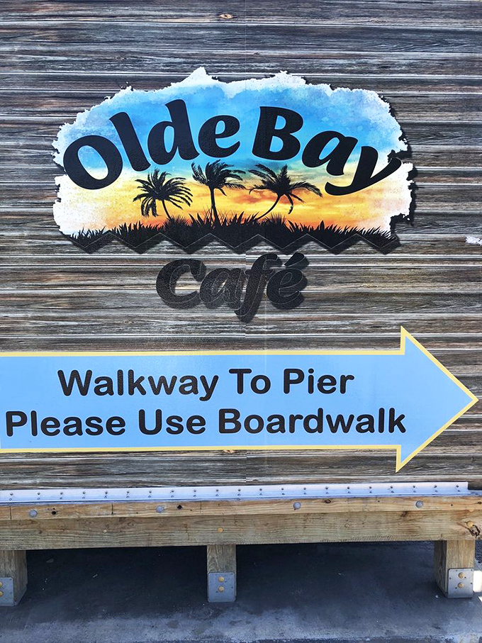 Signage that promises adventure lies ahead. The weathered wood and painted palm trees set the tone for the authentic Florida experience waiting beyond.